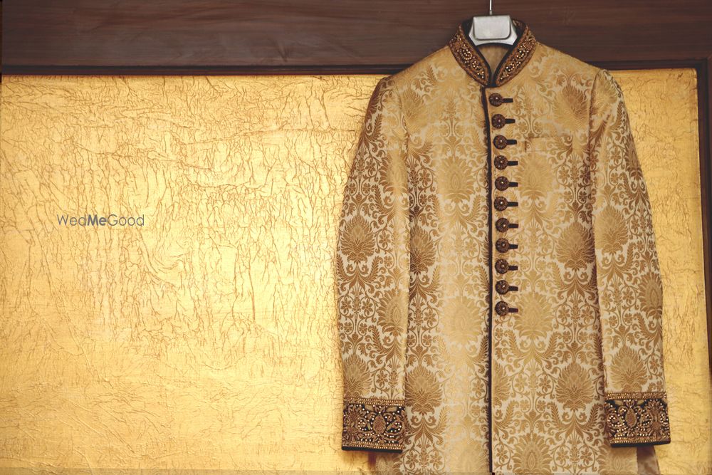 Photo of Cream and Gold Sherwani on a Hanger