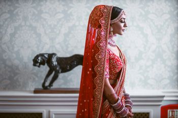 Photo of Bride and groom color-contrasting in red and white
