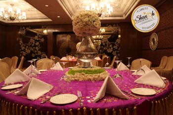Photo of Beautiful outdoor sit down dinner set up with floral and lighting