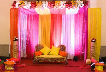 Photo of Colourful mehndi decor idea with kites in photobooth