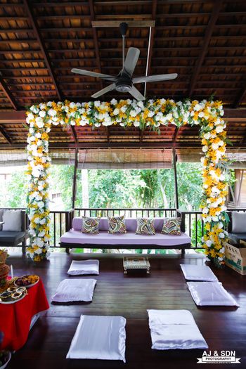 Photo of An open mandap with floral strings and drapes