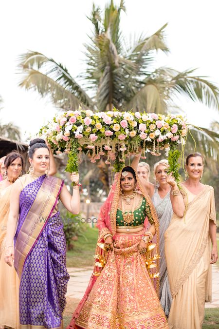 Photo of Mehendi jhoola seating decorated with bougainvilleas.