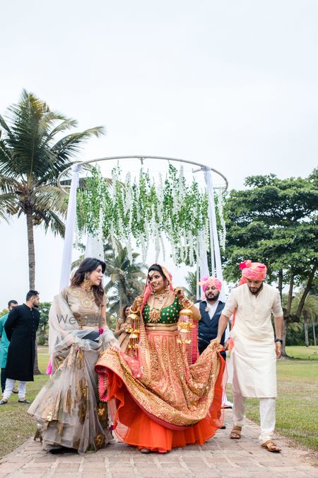 Photo of Mehendi jhoola seating decorated with bougainvilleas.
