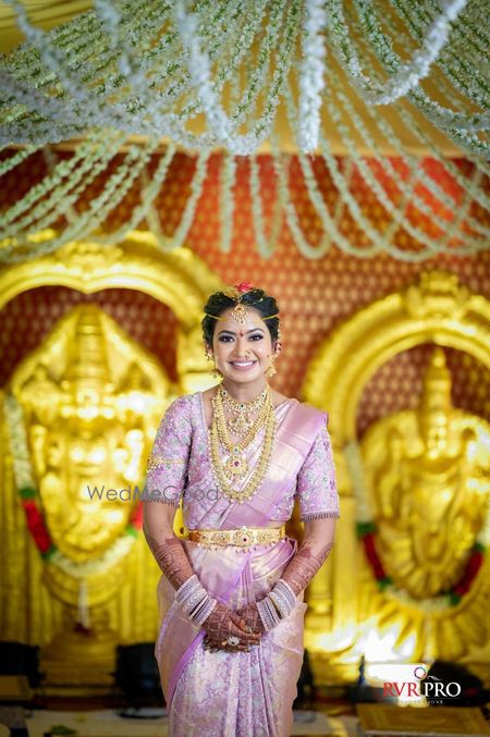 Photo of South Indian bride in gold saree with pink dupatta
