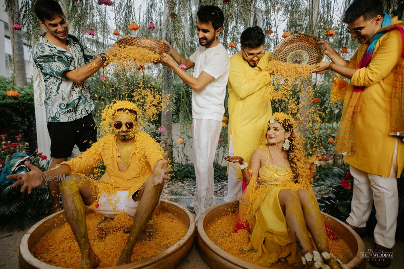 Photo of couple in fun haldi ceremony