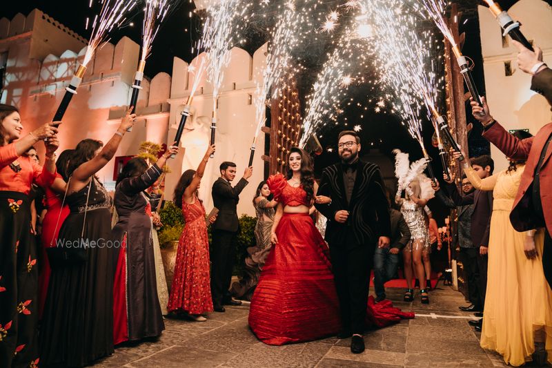 Photo of Couple entry with guests holding cold pyros.