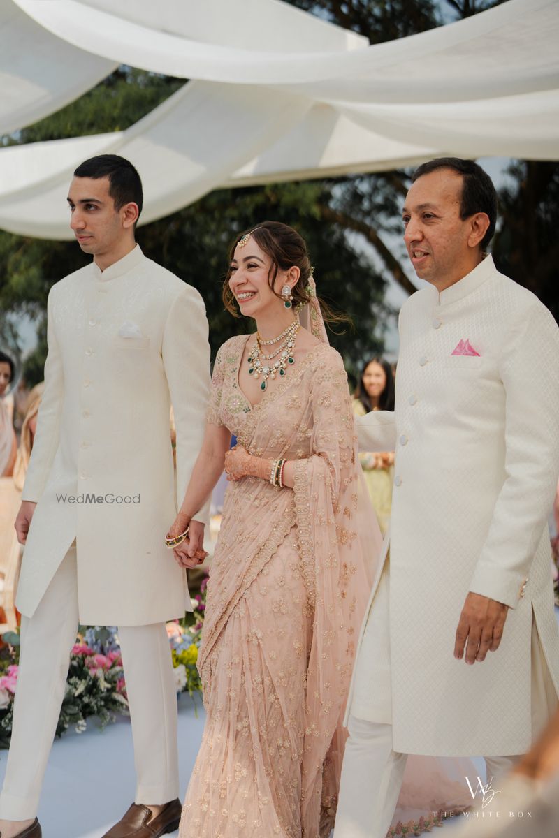 Photo of Happy candid capture of the bride entering the mandap with her ...