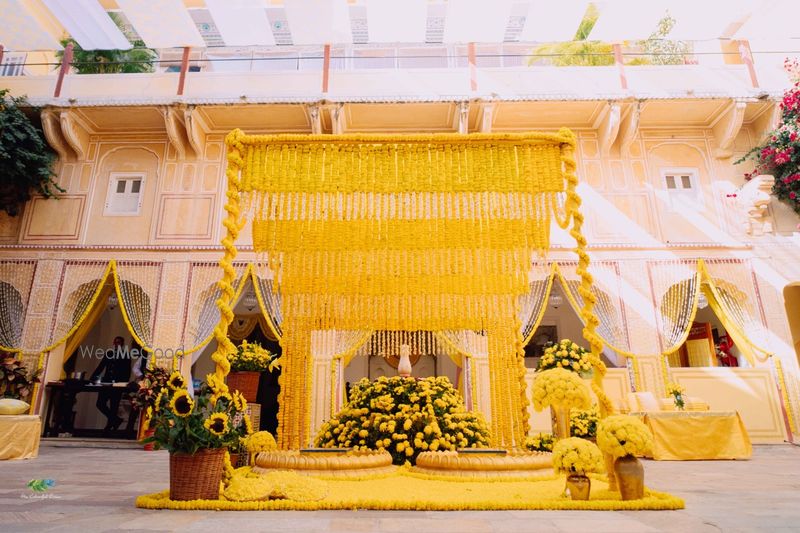 Photo of sunflower haldi seating decor idea with urlis