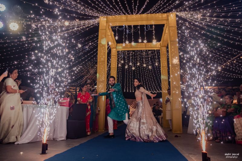 Photo of Bride and groom entry with sparklers at the sangeet