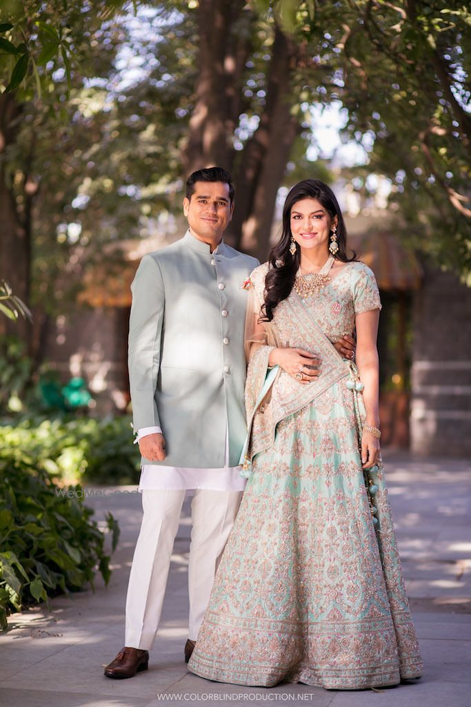 Photo of A bride and groom pose in perfectly coordinated powder blue ...