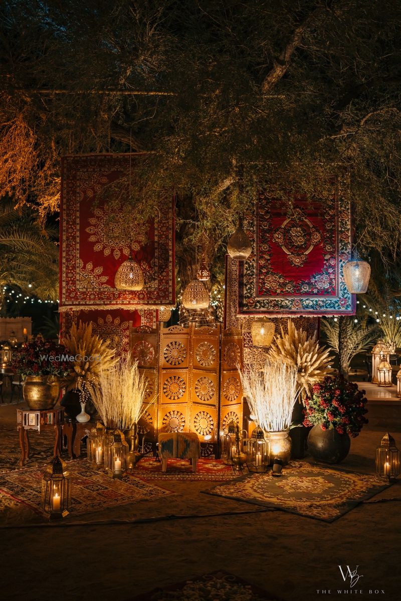 Photo of Middle eastern themed sangeet decor with hanging carpets and ...