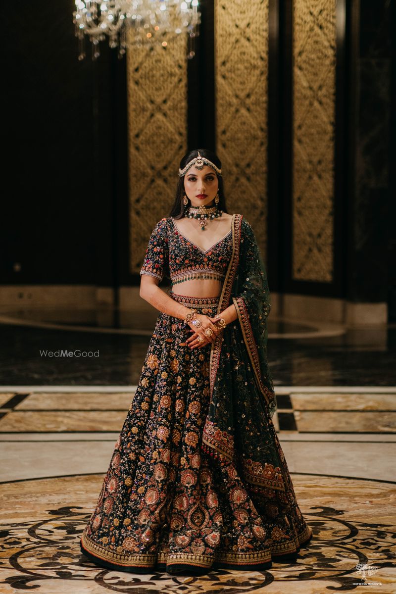 Photo of dark green manish malhotra mehendi look for bride