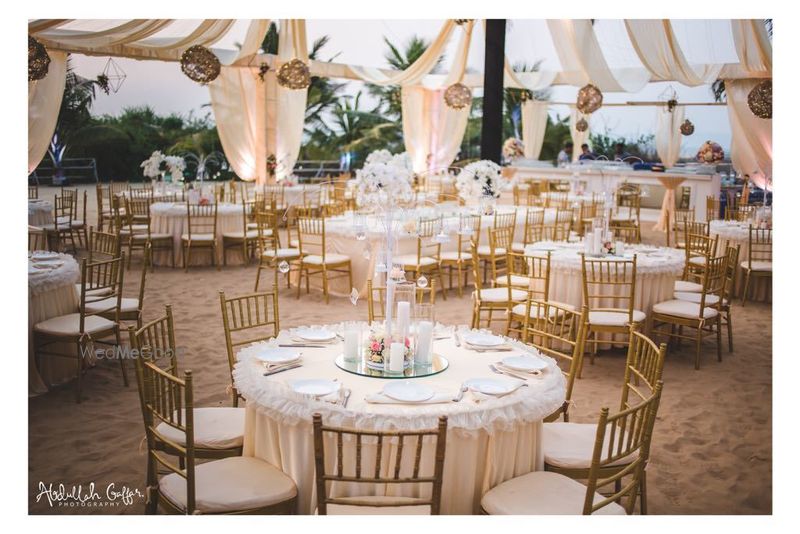 Photo of Round table setting with gold and cream theme