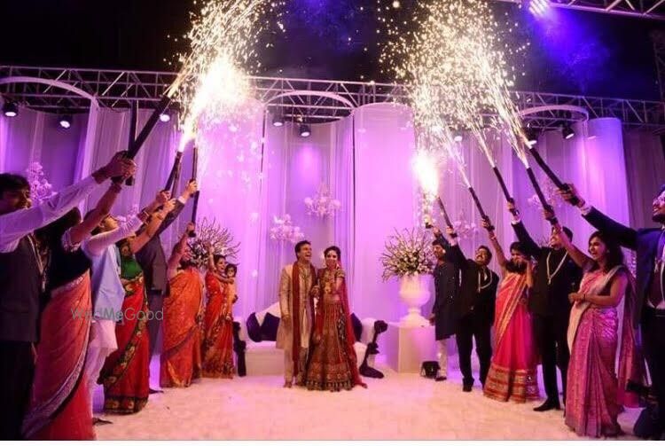 Photo of Couple entering with guests holding cold pyros