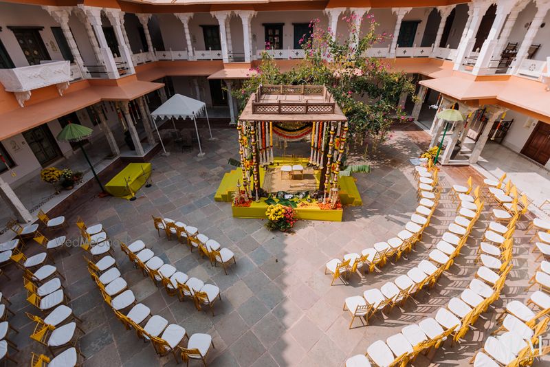 Photo of pretty intimate wedding decor mandap with seating
