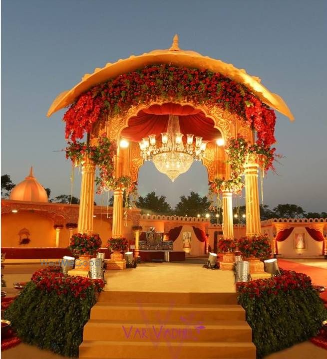 Photo of Beautiful outdoor mandap with hanging chandelier