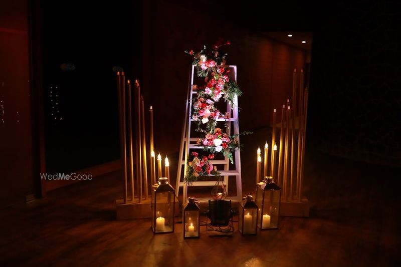 Photo of A white ladder decorated with flower arrangements and some ...