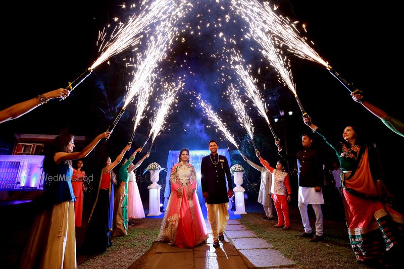Photo of guests holding cold pyros while couple entry