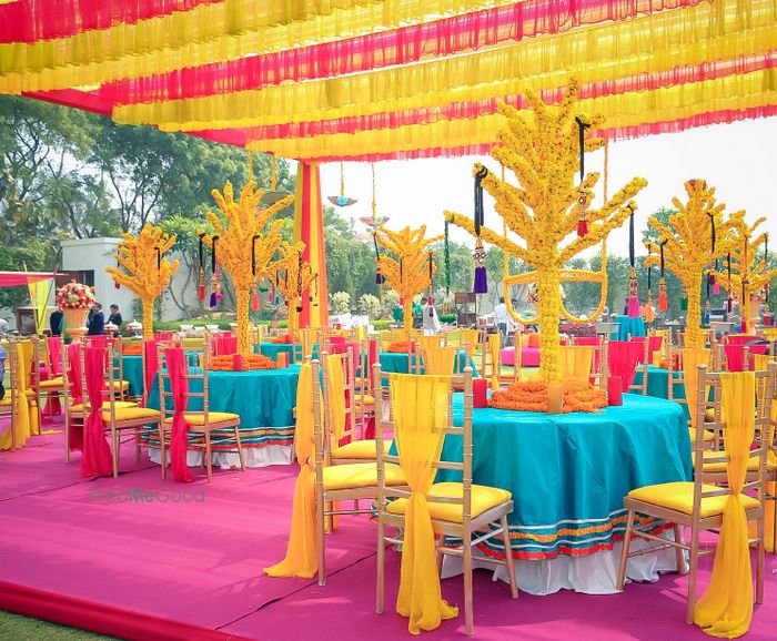 Photo of Colourful Mehendi Decor with Genda Phool Centrepiece
