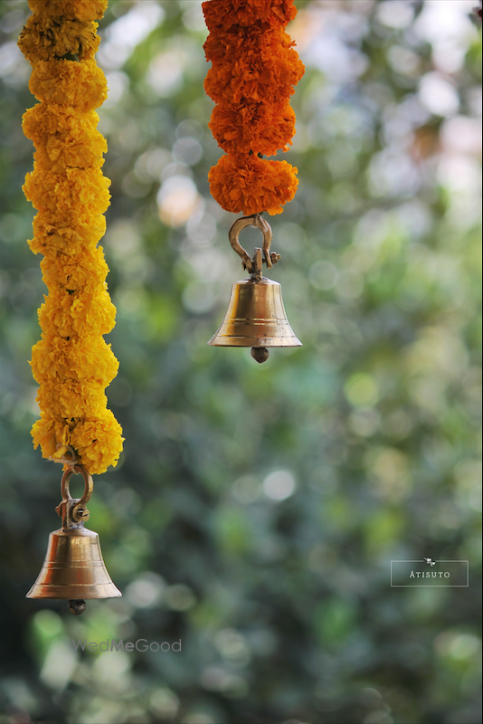 Photo of Genda phool strings with metal temple bells