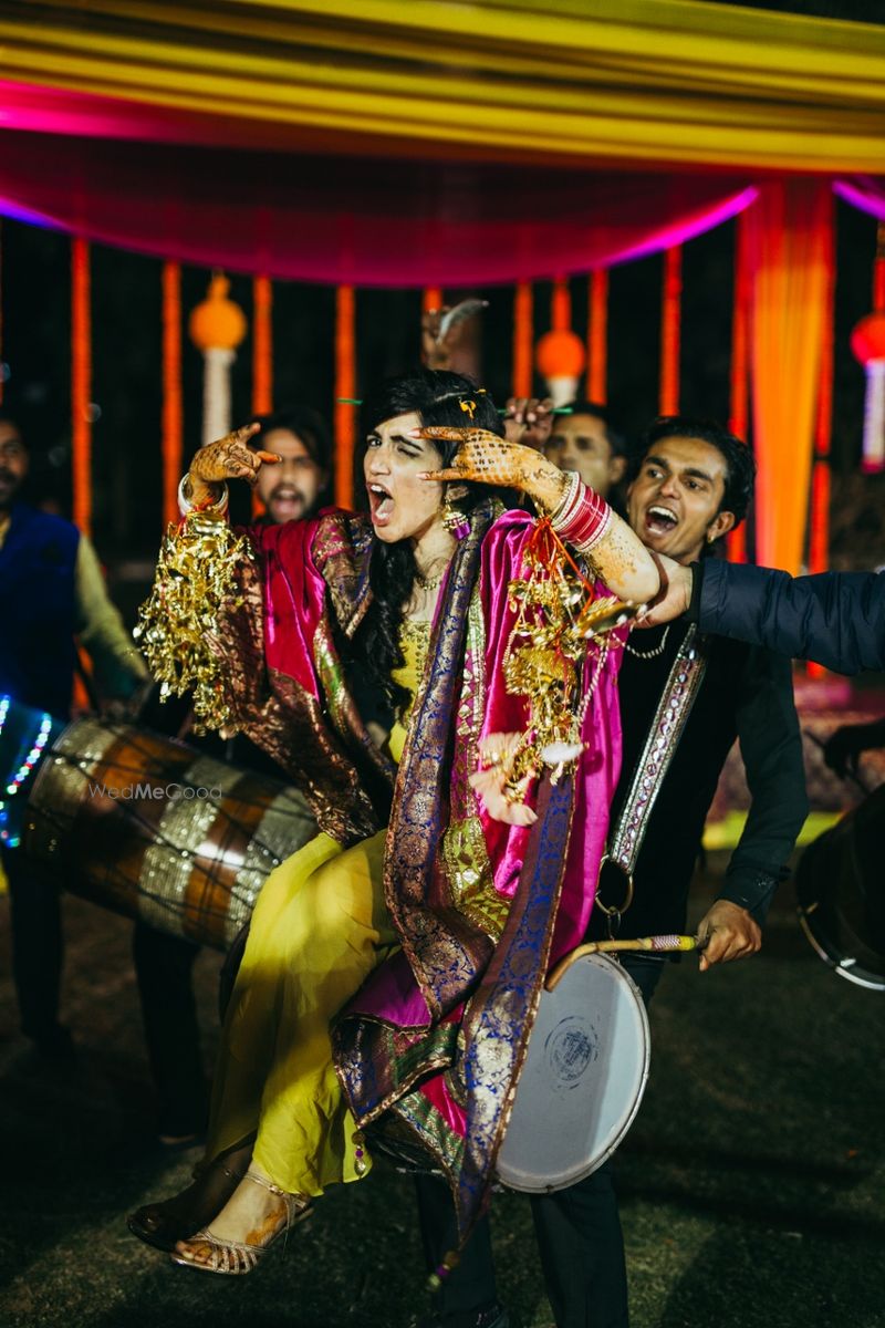 Photo of Fun bridal shot with bride sitting on dhol
