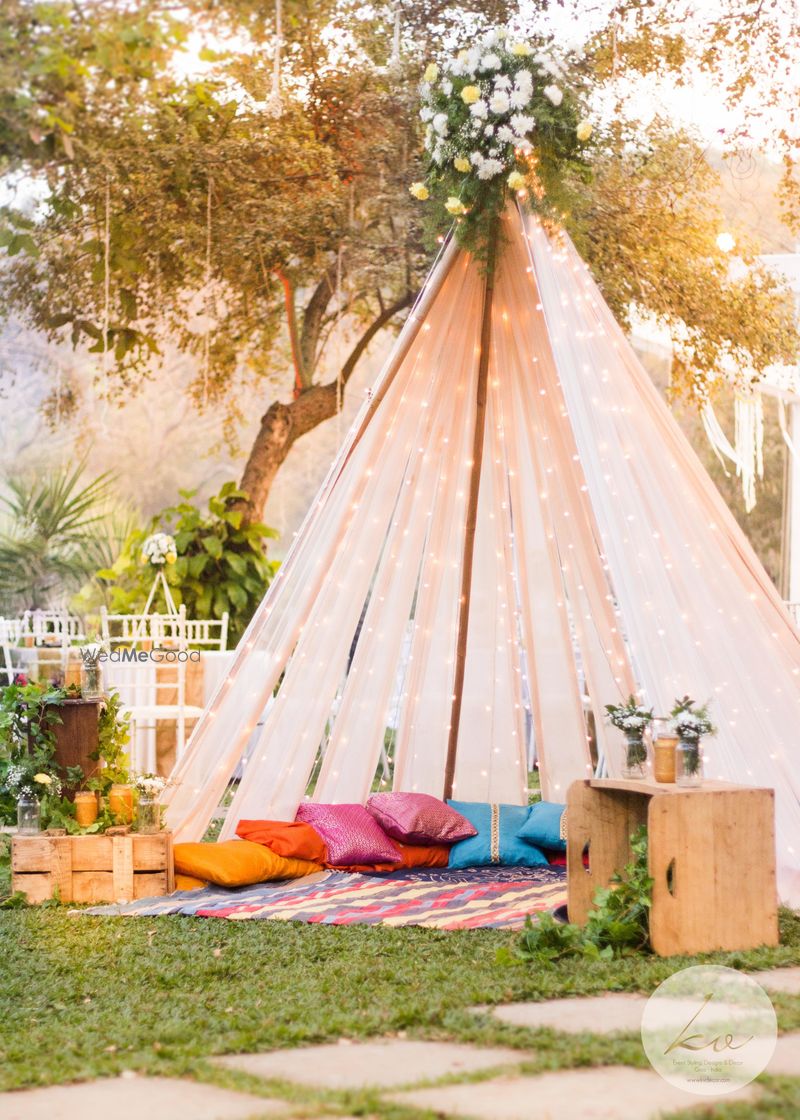 Photo of Beautiful outdoor tents with fairy lights and colourful pillows