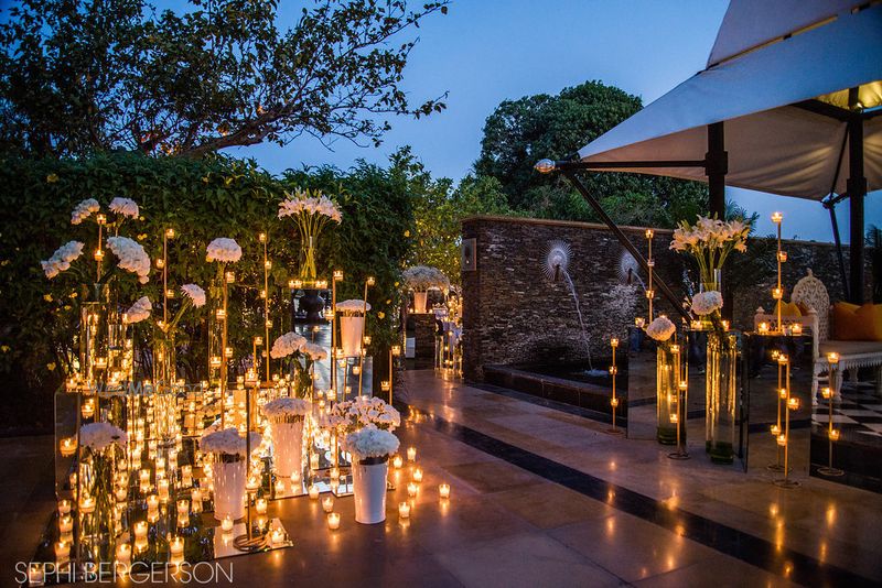 Photo of Elegant night decor with florals and lit candles