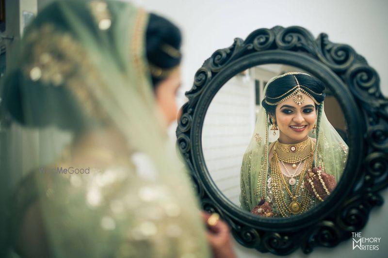 Photo of Bride looking in the mirror shot