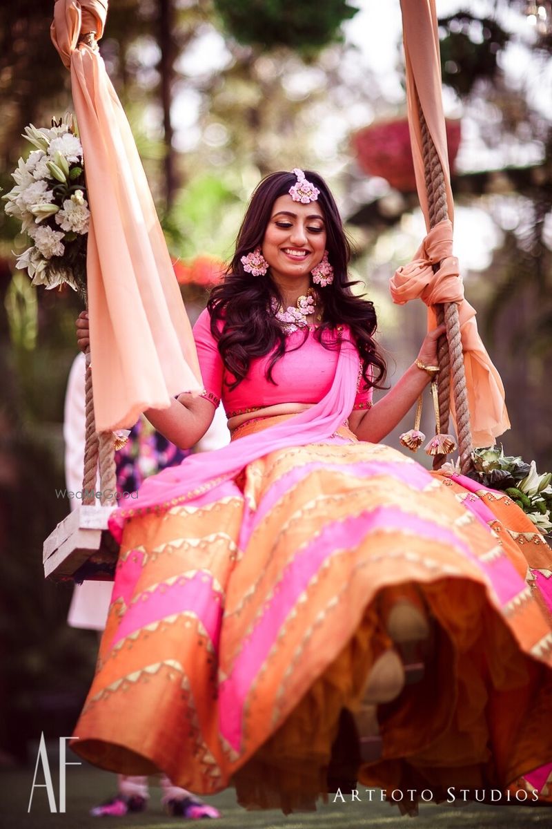 Photo of Mehendi day bridal portrait with bride on swing