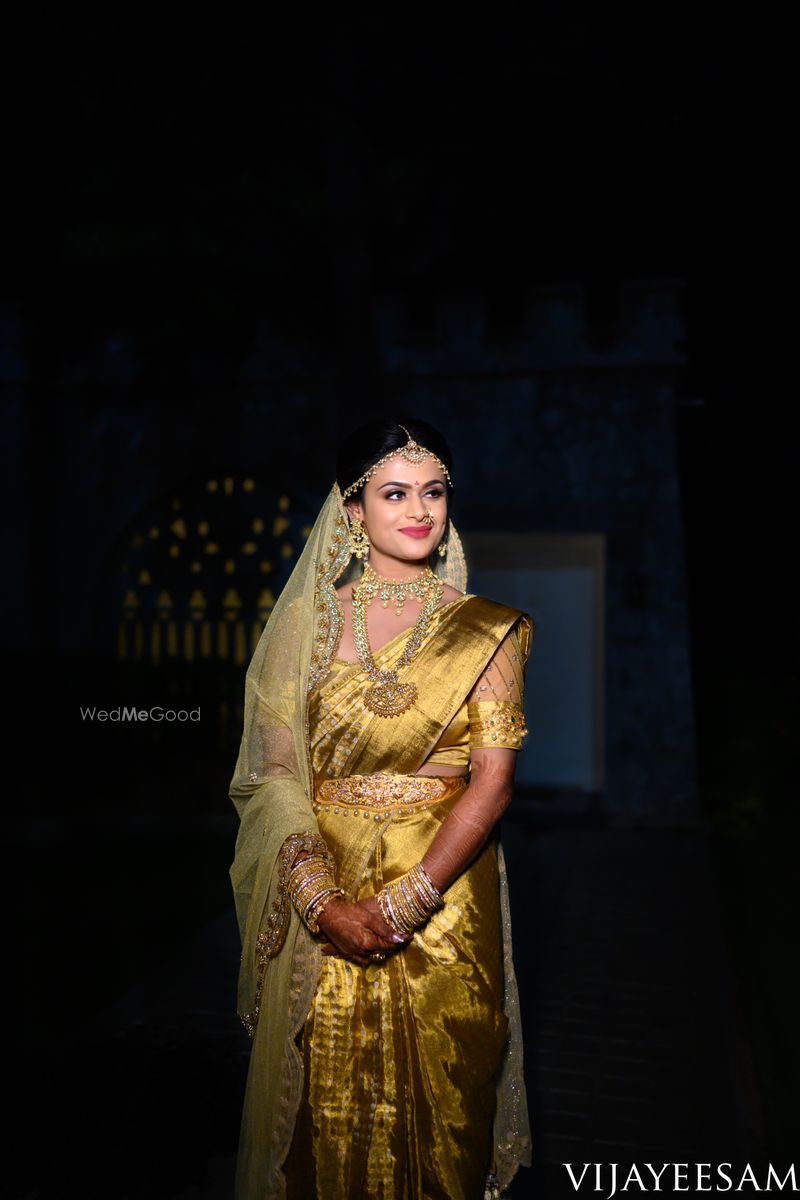 Photo of Smiling south indian bride in a gold saree