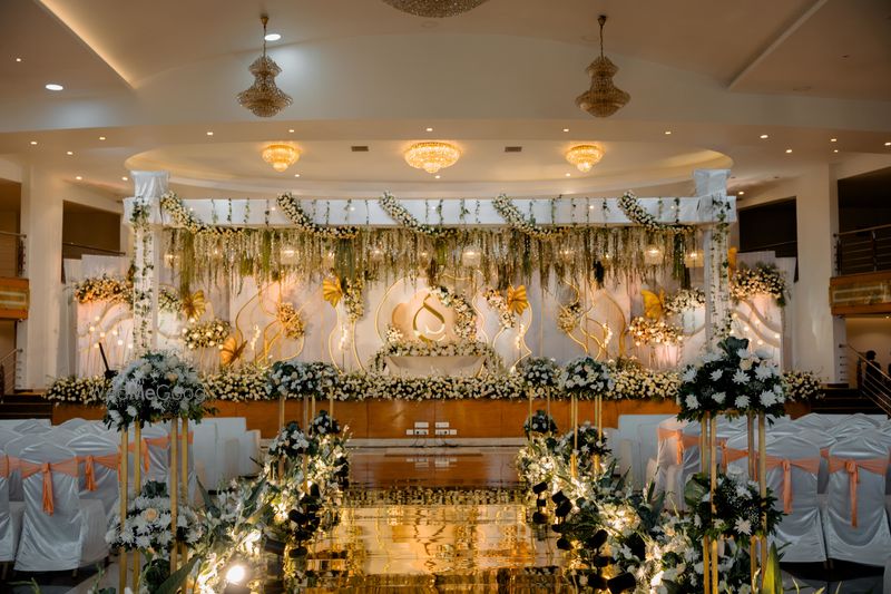 Photo of Grand reception stage decor in all white and a mirror aisle