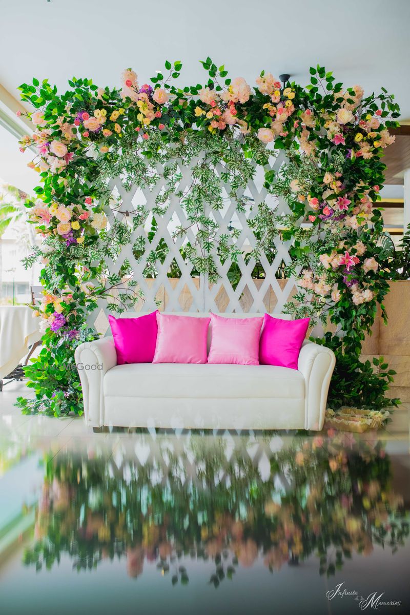 Photo of Mehendi photobooth and bridal seat with floral decor