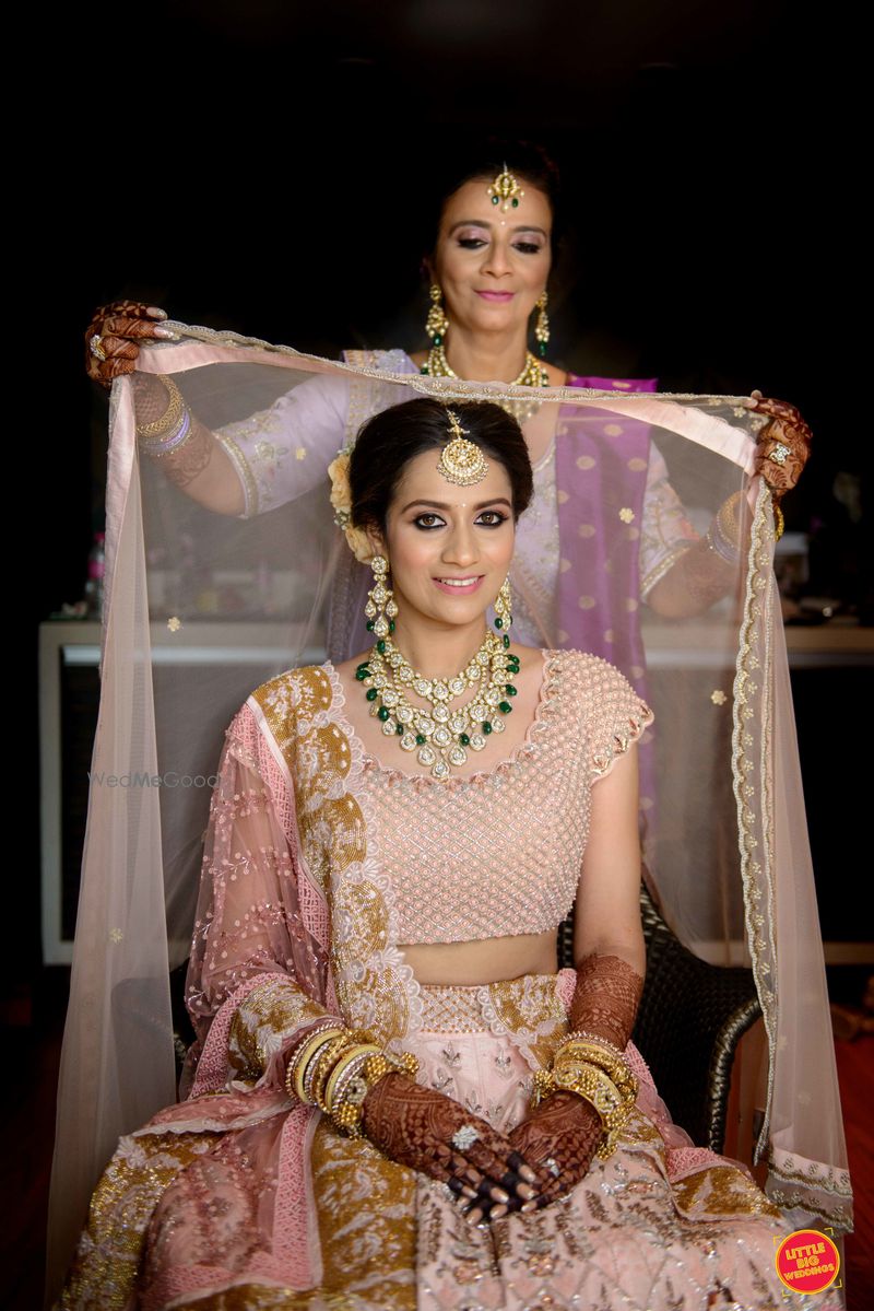 Photo of mother of the bride placing on the head shot