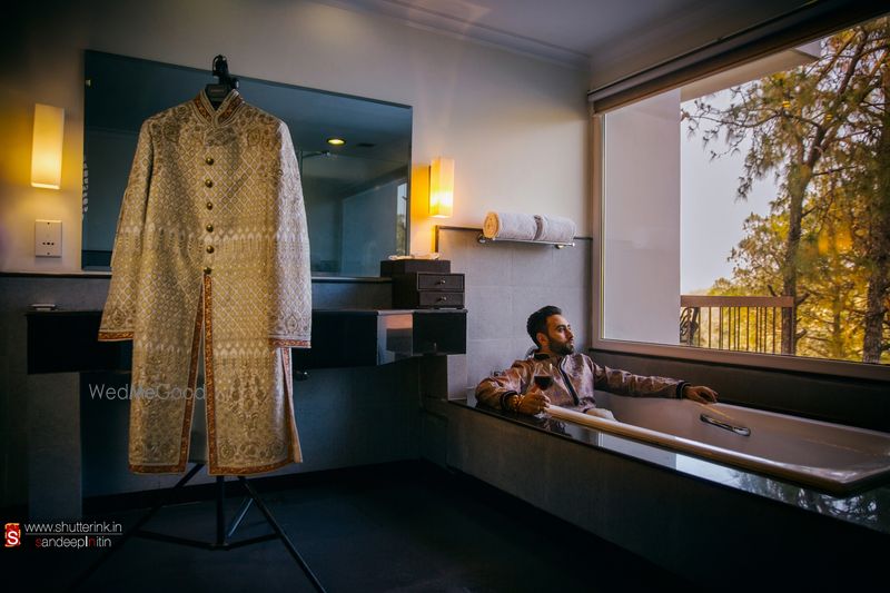 Photo of Groom in Bathing Tub with Hanging Sherwani