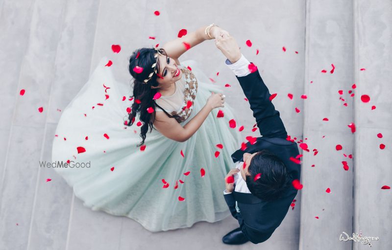 Photo of Couple dancing shot with rose petals being showered