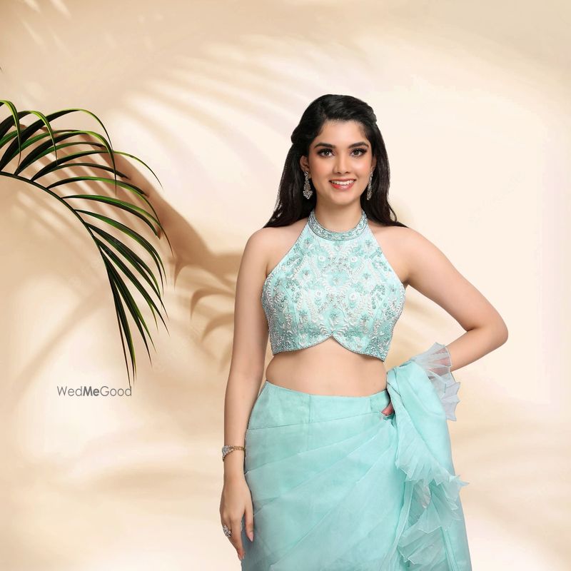 blue colour saree with dramatic pleated ruffles at the hem and trailing ...