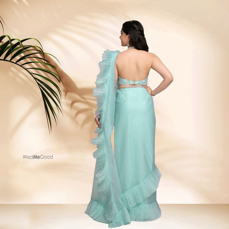 blue colour saree with dramatic pleated ruffles at the hem and trailing ...